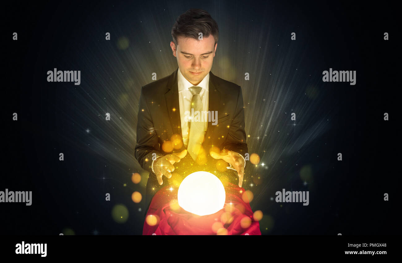 Gorgeous businessman sitting with sparkling magic ball in his lap Stock ...