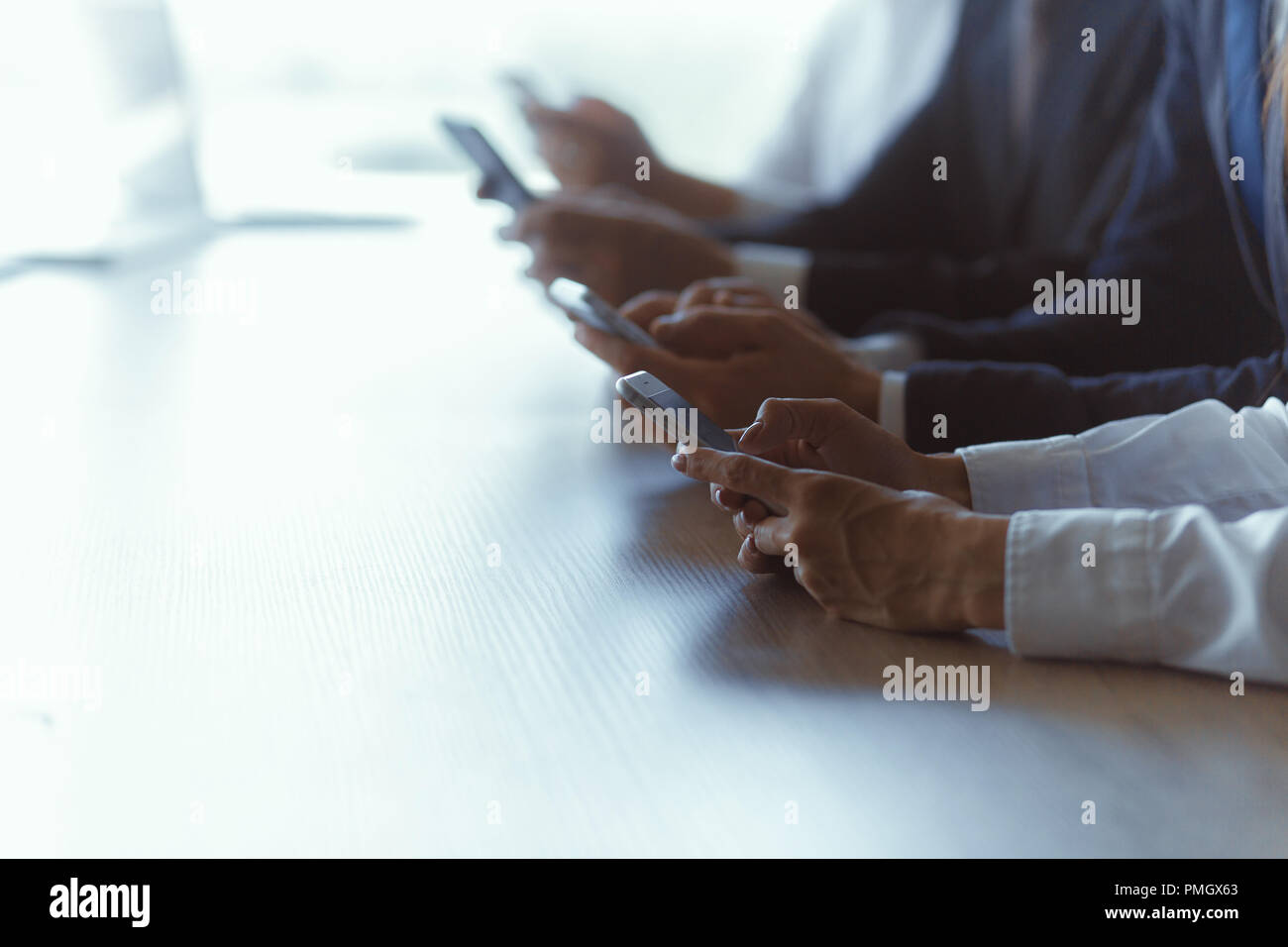 Businesspeople hands using phone Stock Photo - Alamy