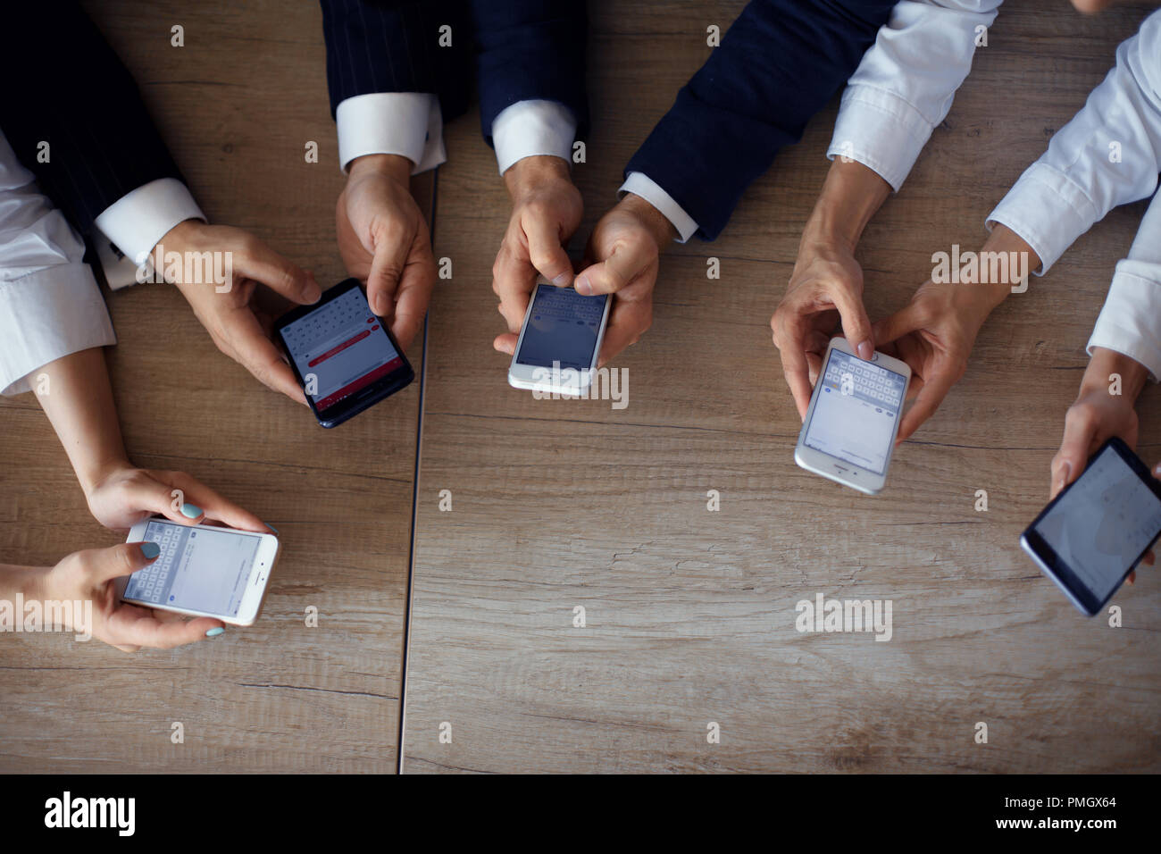 Businesspeople hands using phone Stock Photo - Alamy