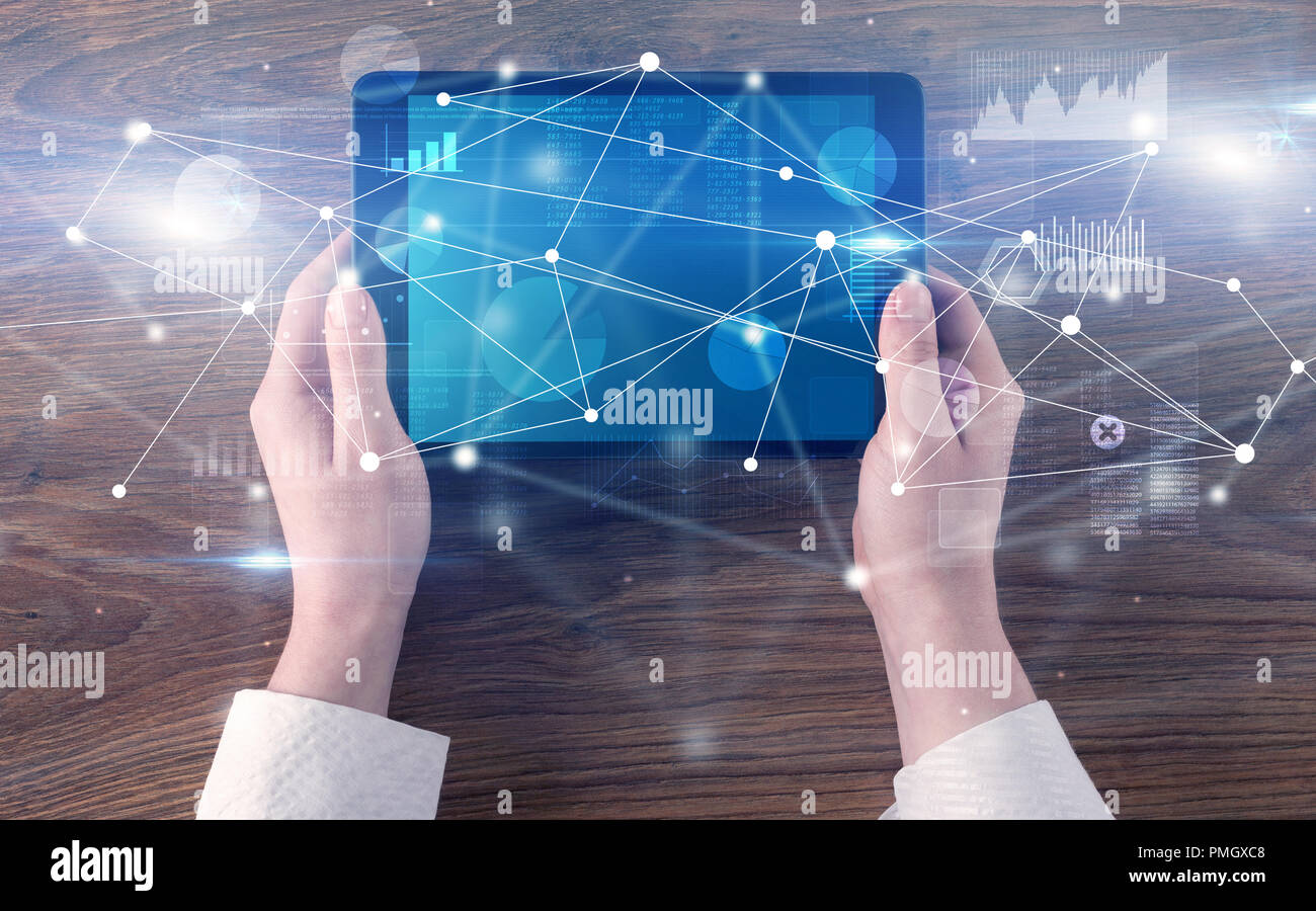 Hand using tablet with linking graphs charts report and informational ...
