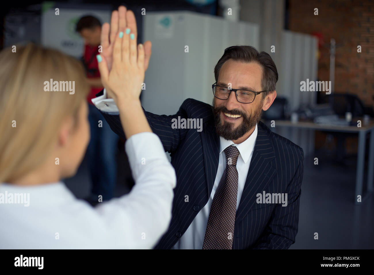 Business people giving five after signing contract Stock Photo - Alamy