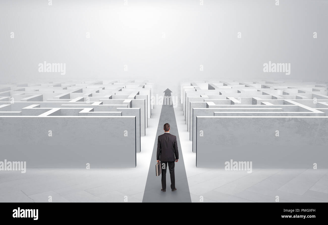 Businessman going straight ahead on a red carpet arrow between two maze ... Businessman going straight ahead on a red carpet arrow between two maze ...