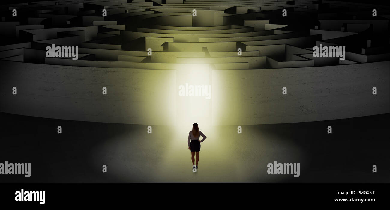 Woman getting ready to enter a concentric labyrinth with lighted ...