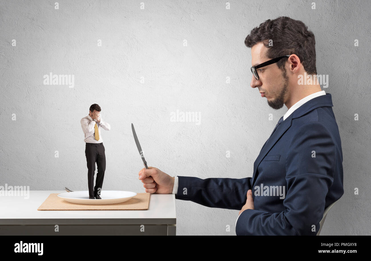 Tiny scared weak businessman almost devoured by great power Stock Photo ...