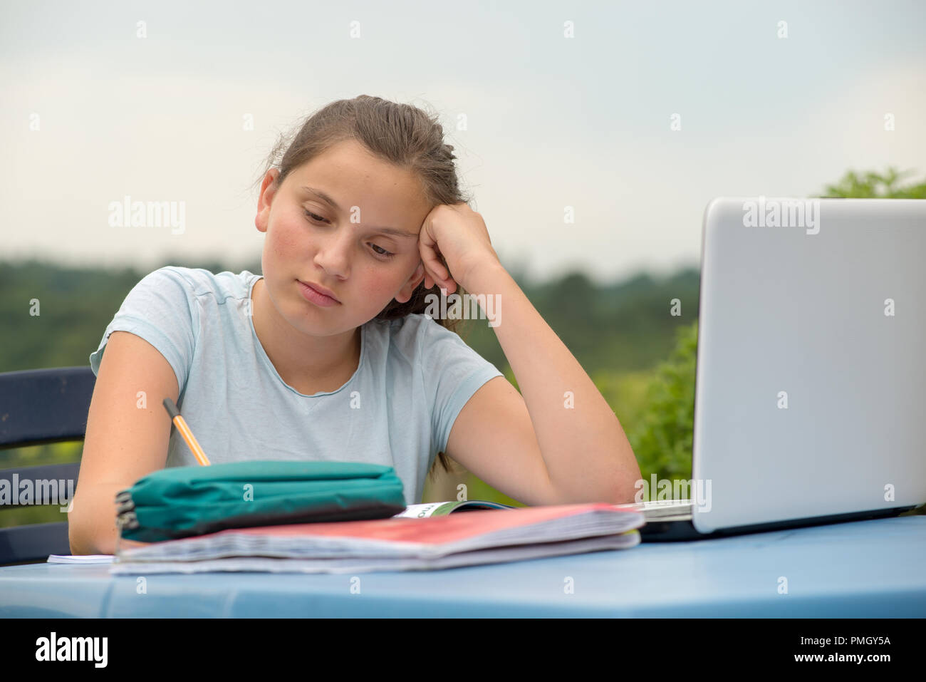 Girl doing homework in garden hi-res stock photography and images - Alamy
