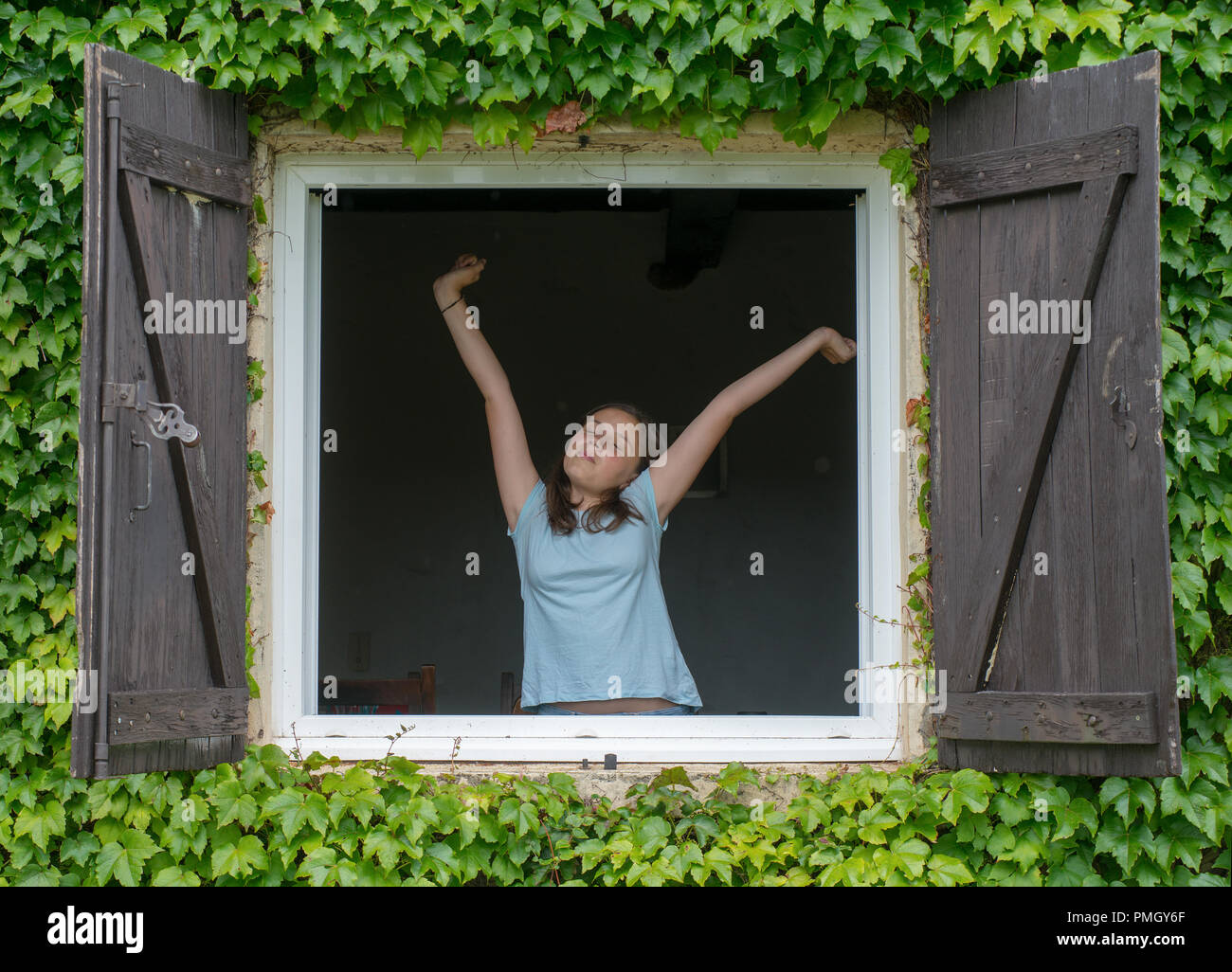 a teenage girl opening the window in the morning Stock Photo - Alamy