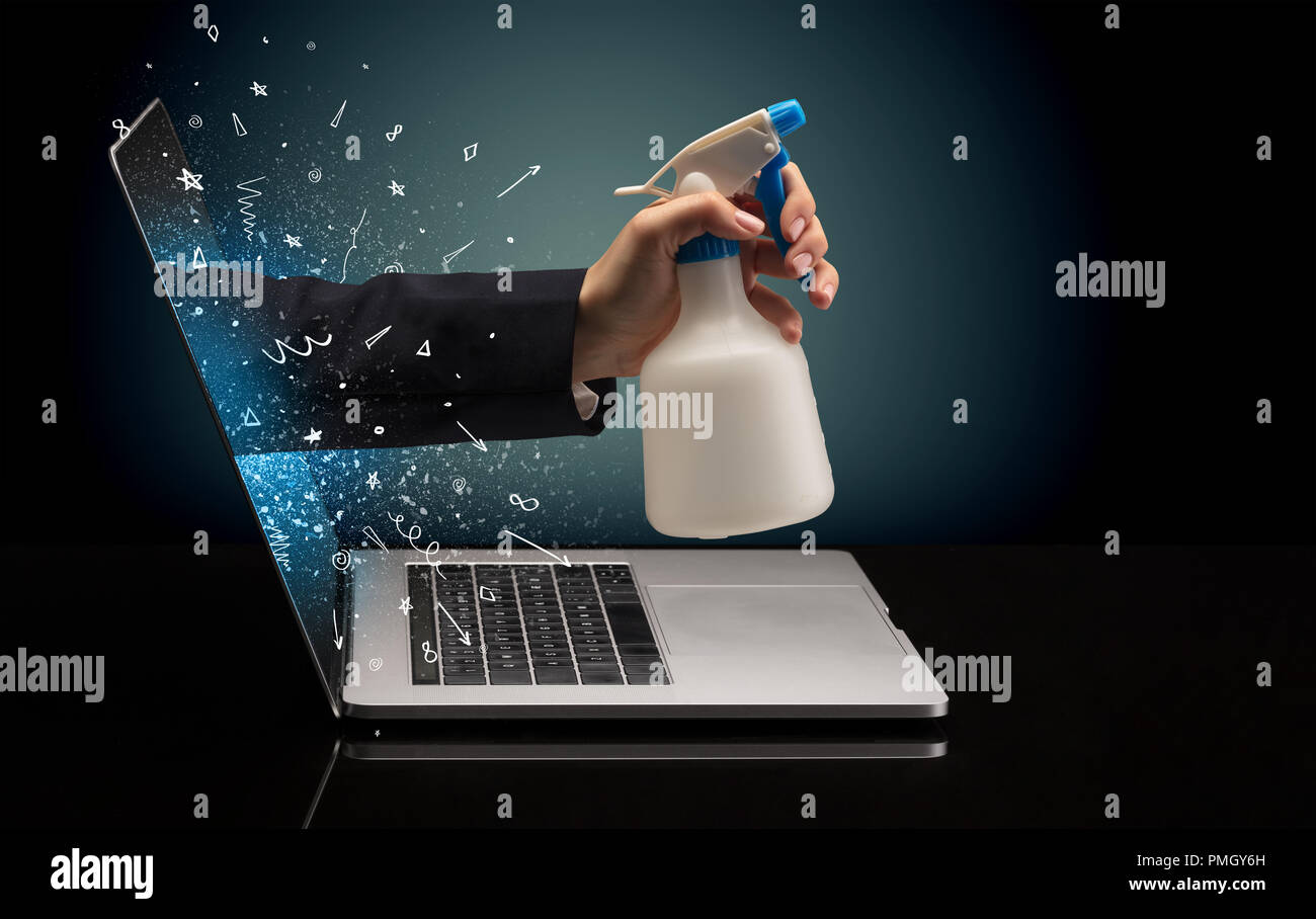 Hand with spray coming out of a laptop with sparkling effects Stock ...