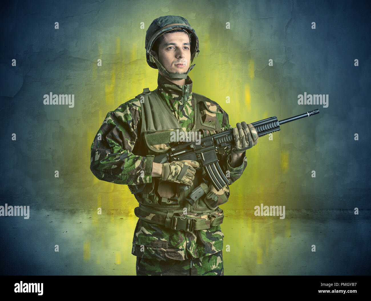 Hazard, menace soldier in a ruined crumbly building with arms on his ...