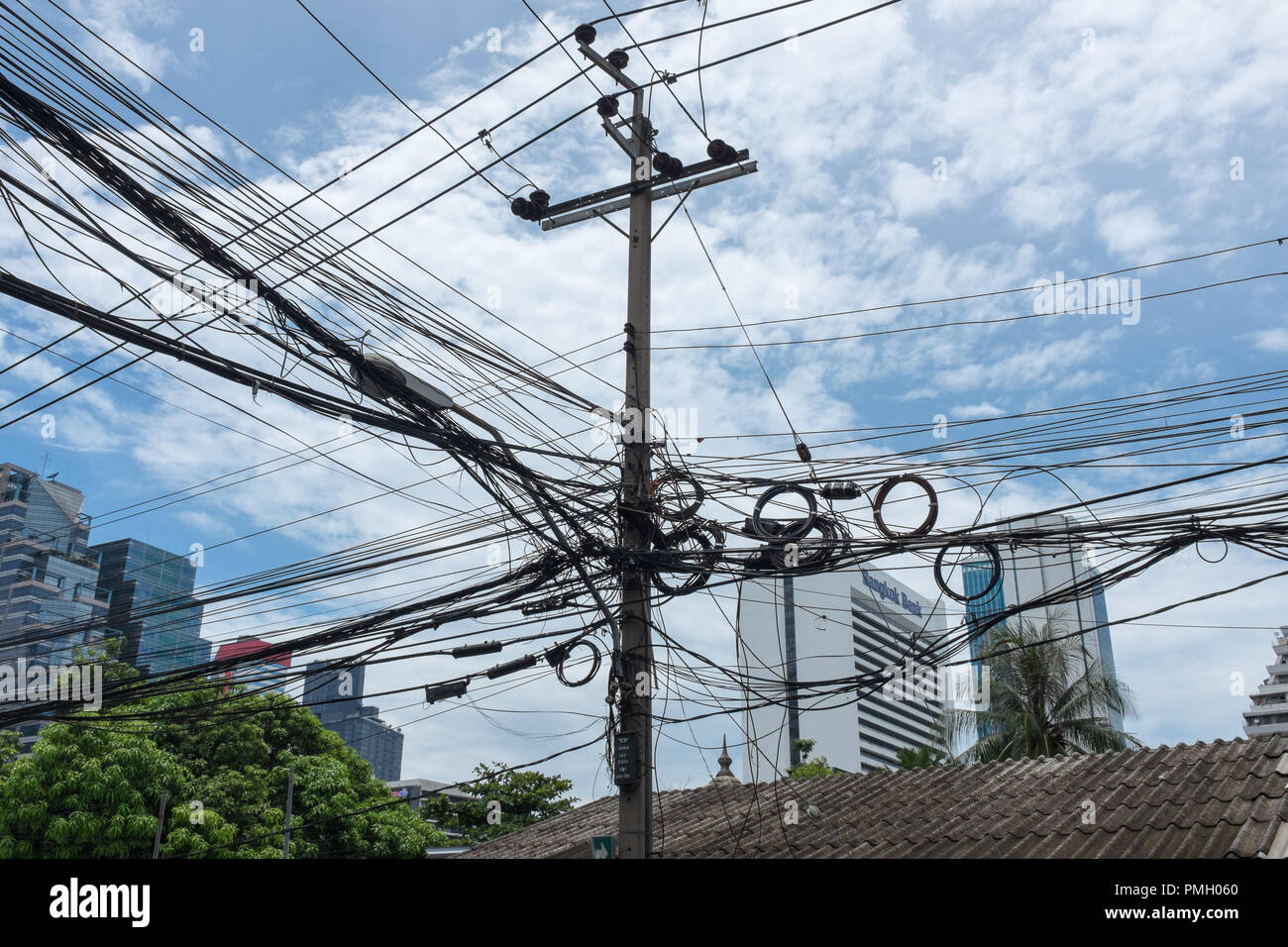 Multiple electricity cables hanging above the street in Bangkok ...