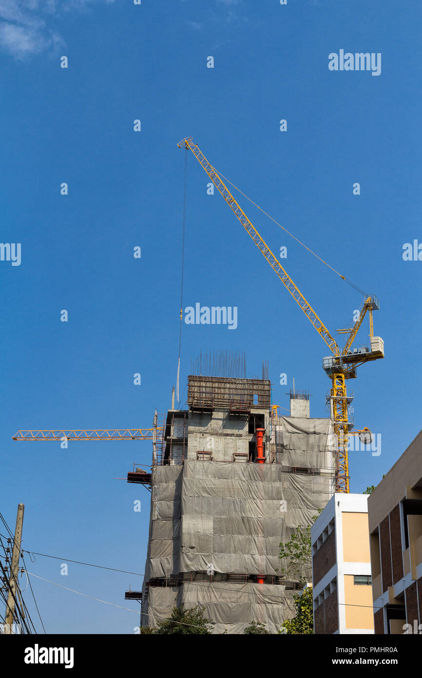 Lifting crane and building in construction site Stock Photo - Alamy