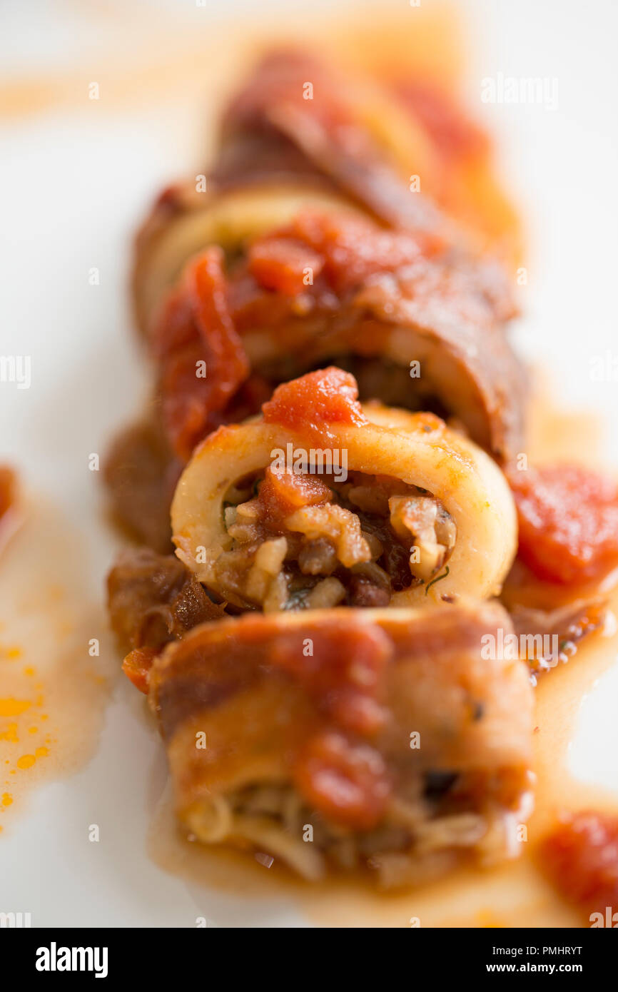 A single stuffed squid tube that has been sliced. The squid was a ...