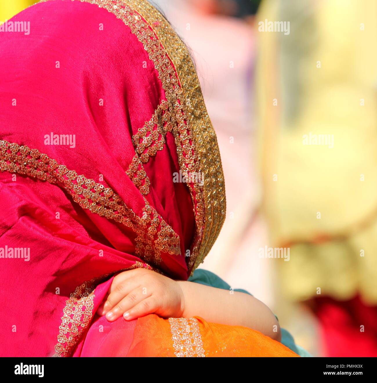 arm of child and his young mother with veil Stock Photo - Alamy