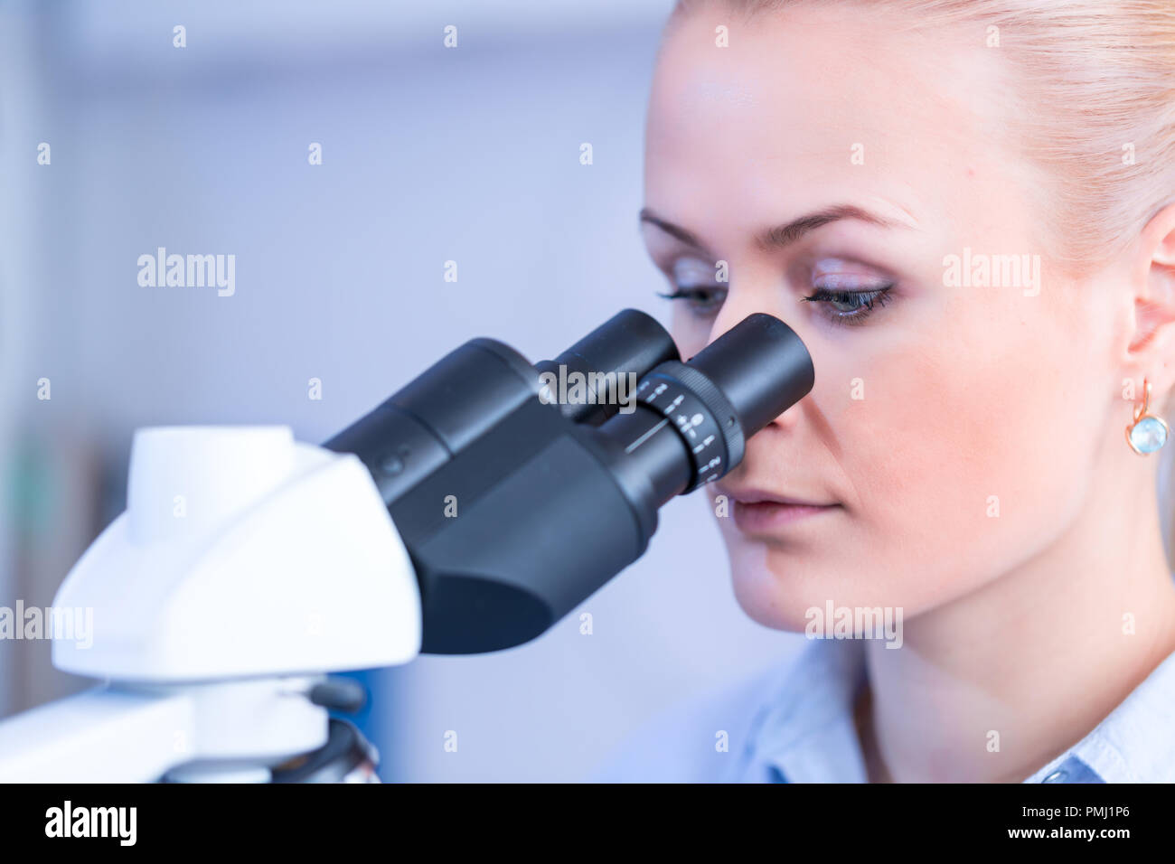 Girl with a slide for the microscope University Hospital. Attractive ...