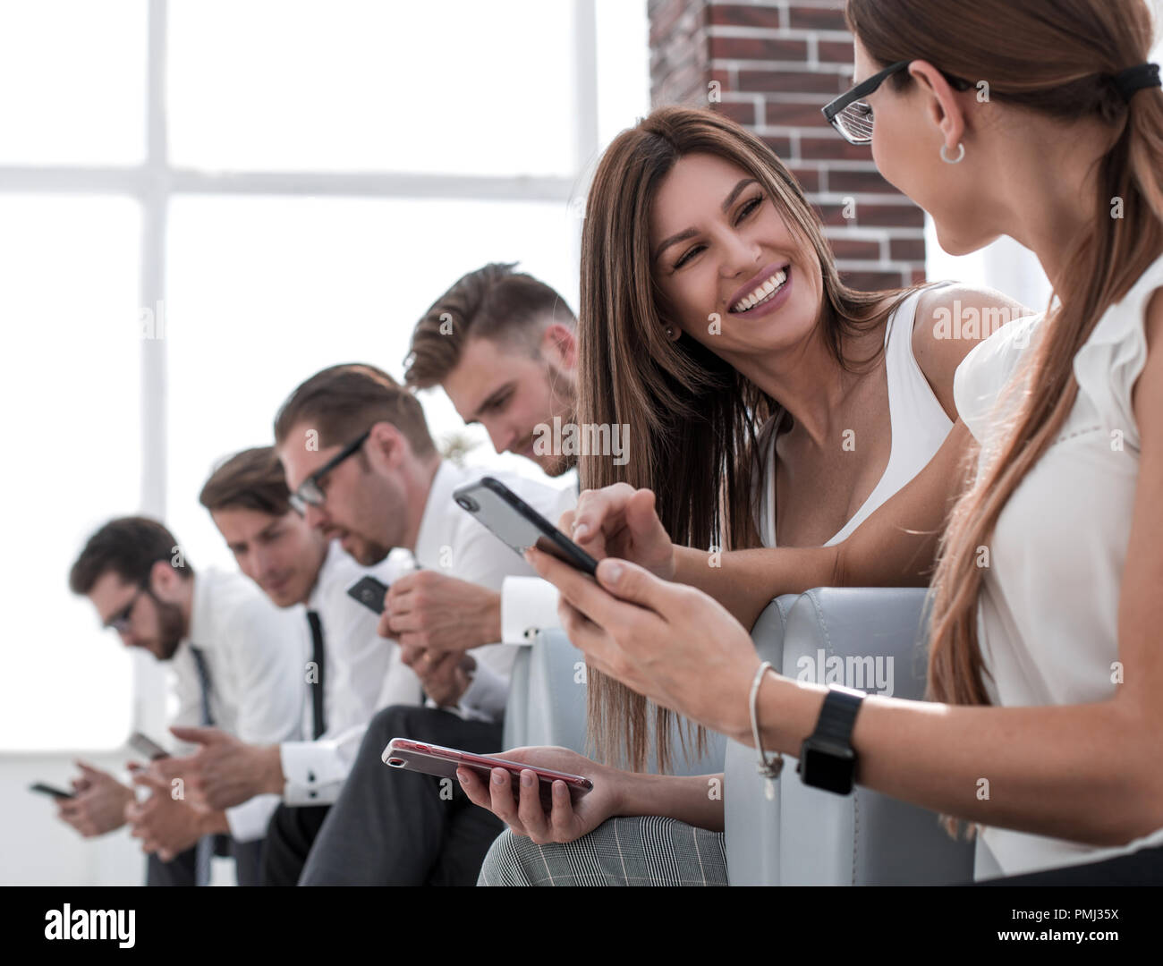 employees discussing something in the waiting room Stock Photo - Alamy