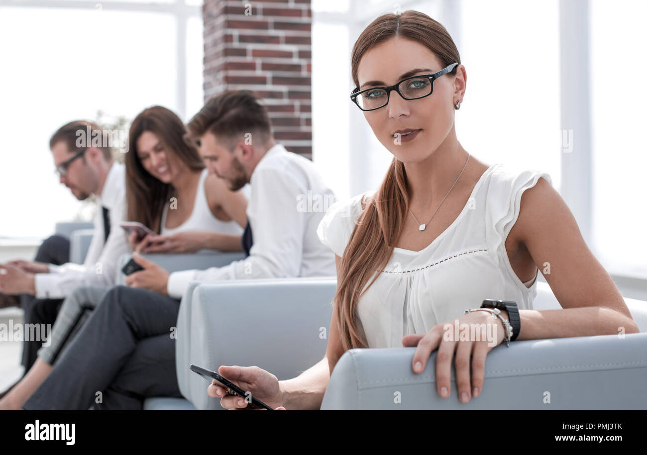 young business woman sitting in office waiting room Stock Photo - Alamy