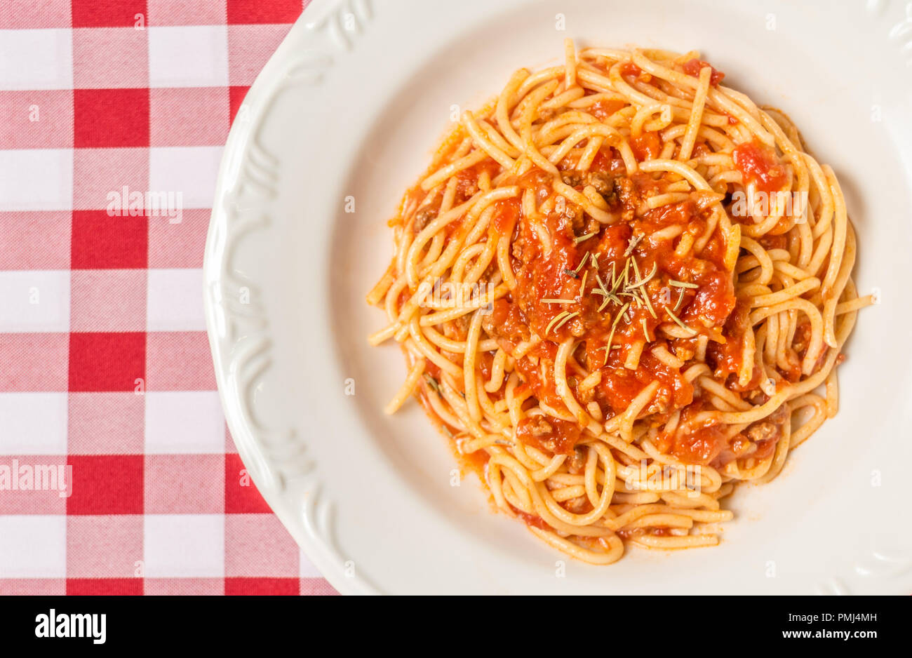 Spaghetti over a red and white checkered background Stock Photo - Alamy