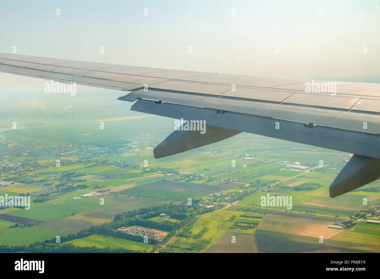 Airplane wing during landing with flaps down Stock Photo - Alamy
