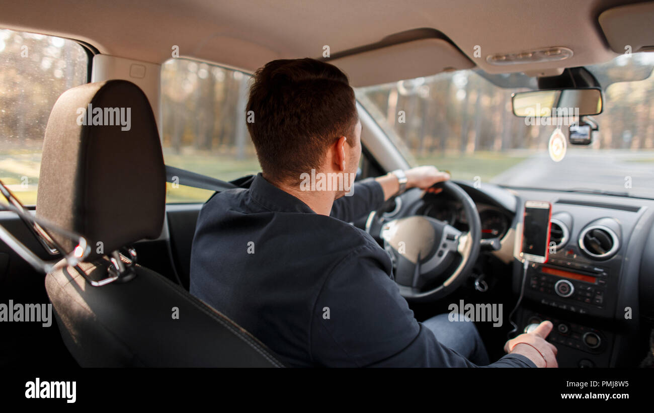Successful young man drives a car on a sunny day Stock Photo - Alamy