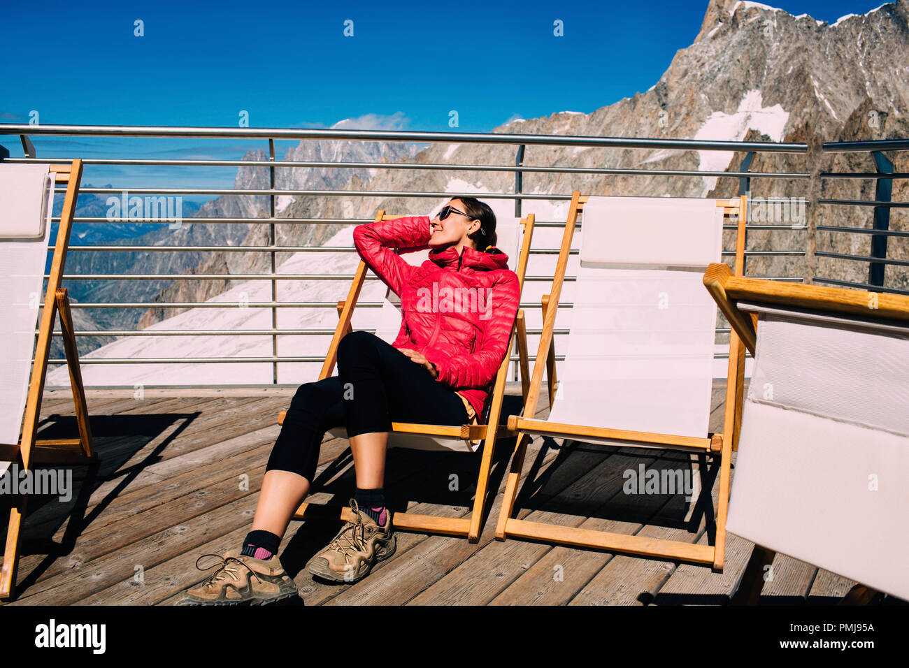 Tourist resting on Chaise Lounges, at observation deck Punta Helbronner ...