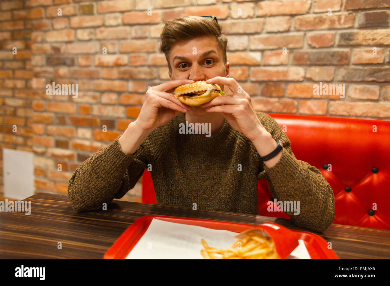 Young man eats junk food hi-res stock photography and images - Alamy