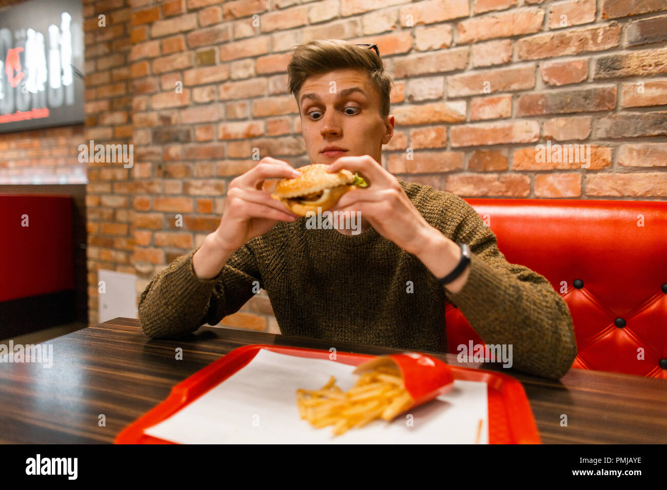 Young man eats junk food hi-res stock photography and images - Alamy