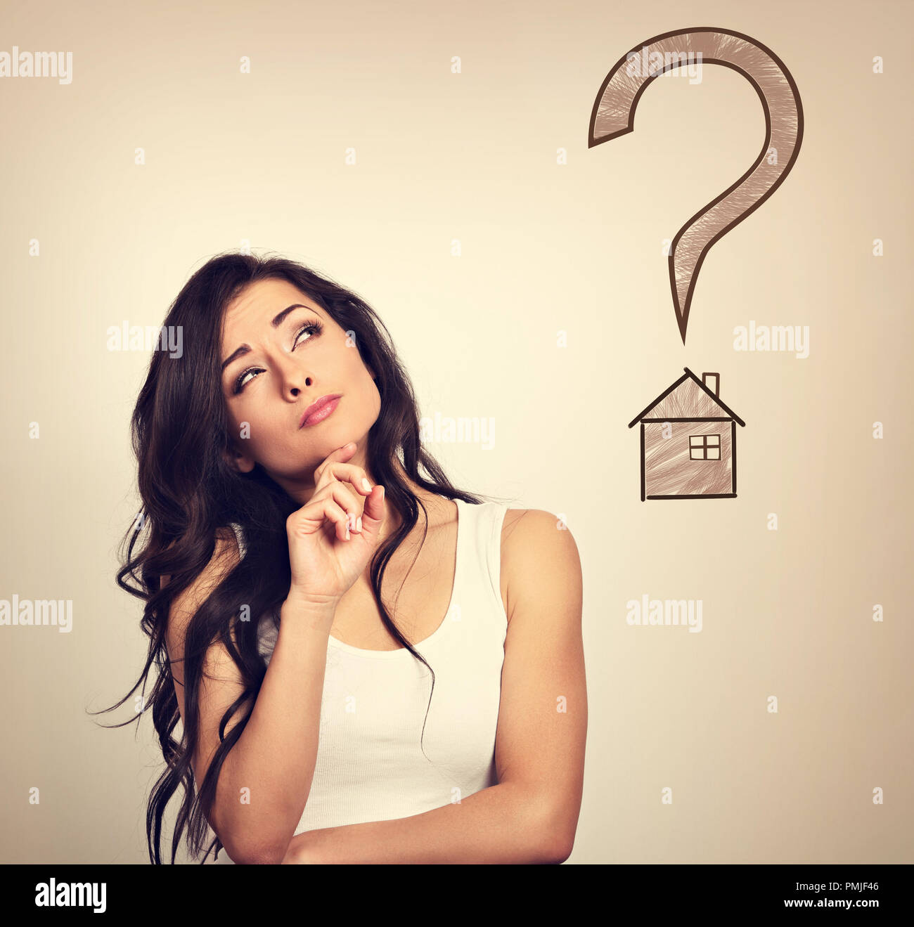 Beautiful serious thinking woman looking up on illustration house and ...