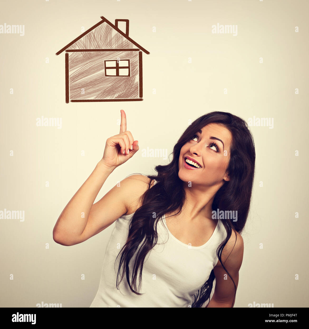 Beautiful excited casual woman pointing the finger up on small ...