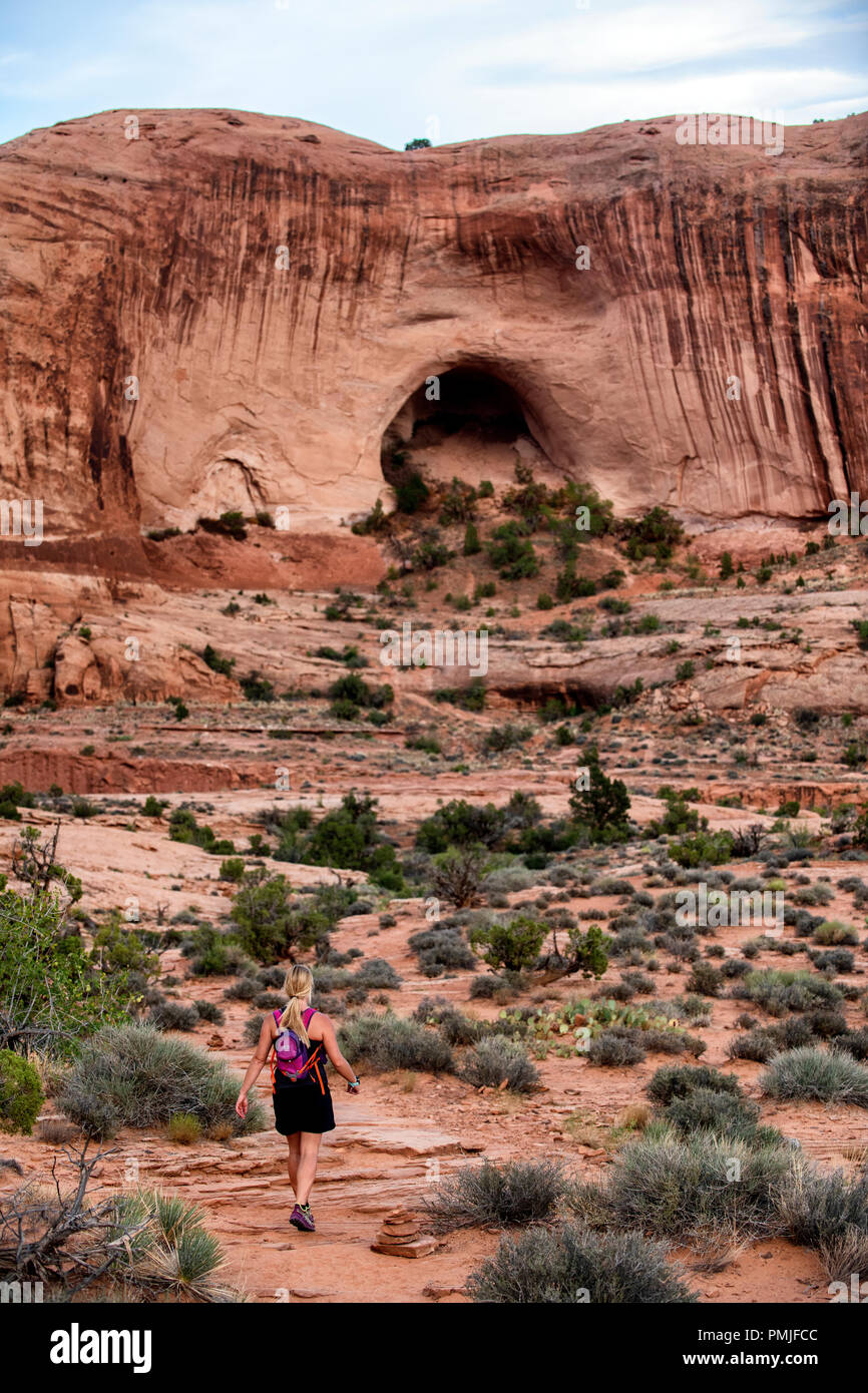 A woman hikes the trail towards Corona Arch, Moab, Utah, USA Stock ...
