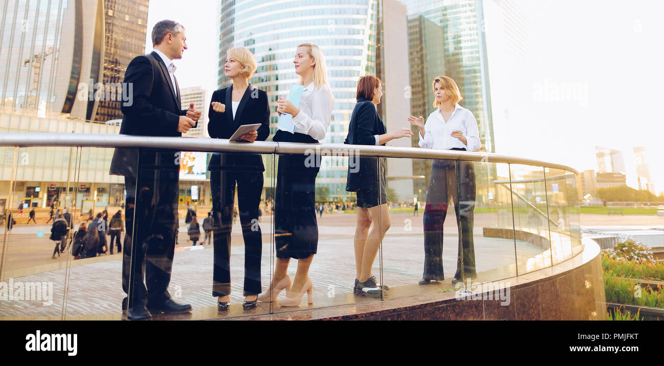 Happy business team members talking outside in Stock Photo - Alamy