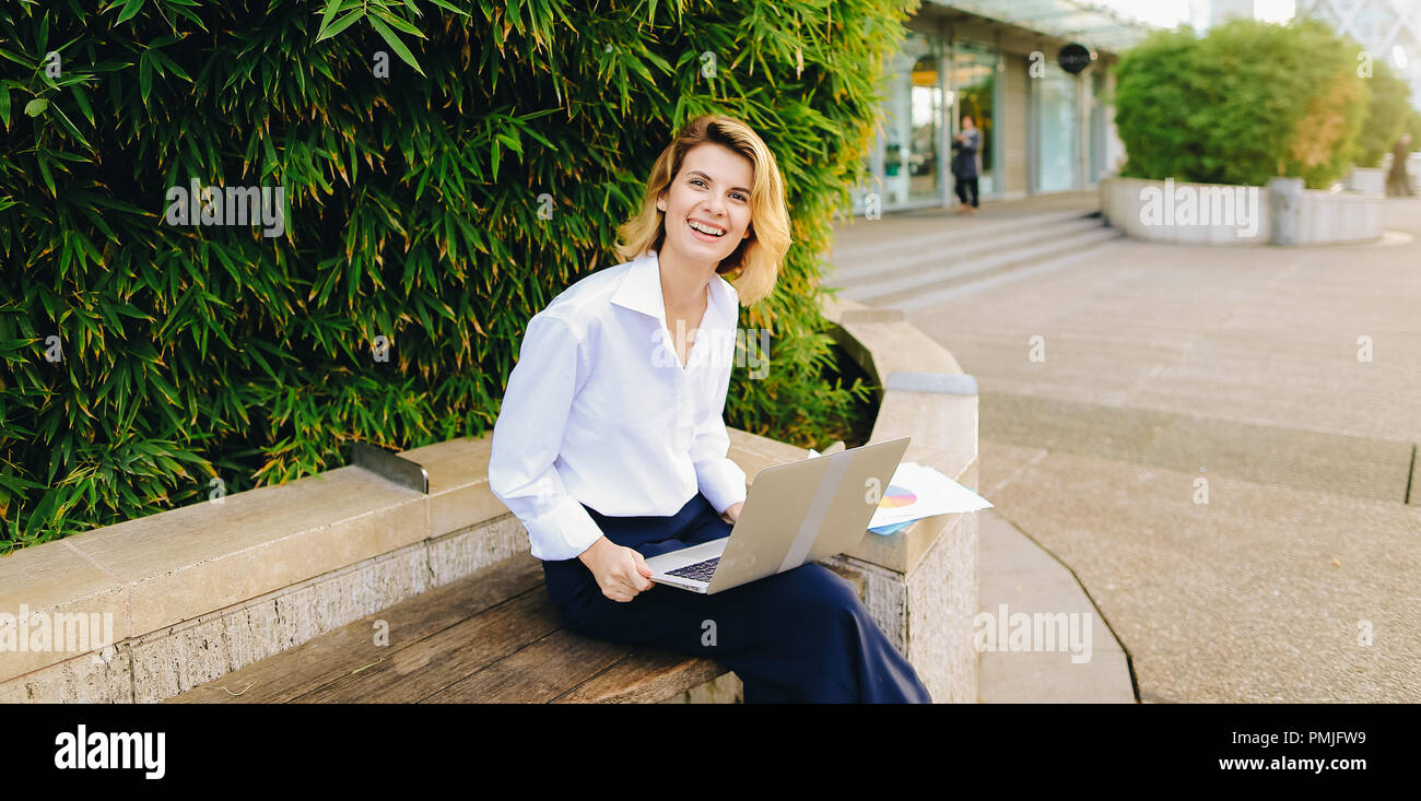 Statistician working outside with laptop and color diagrams Stock Photo ...