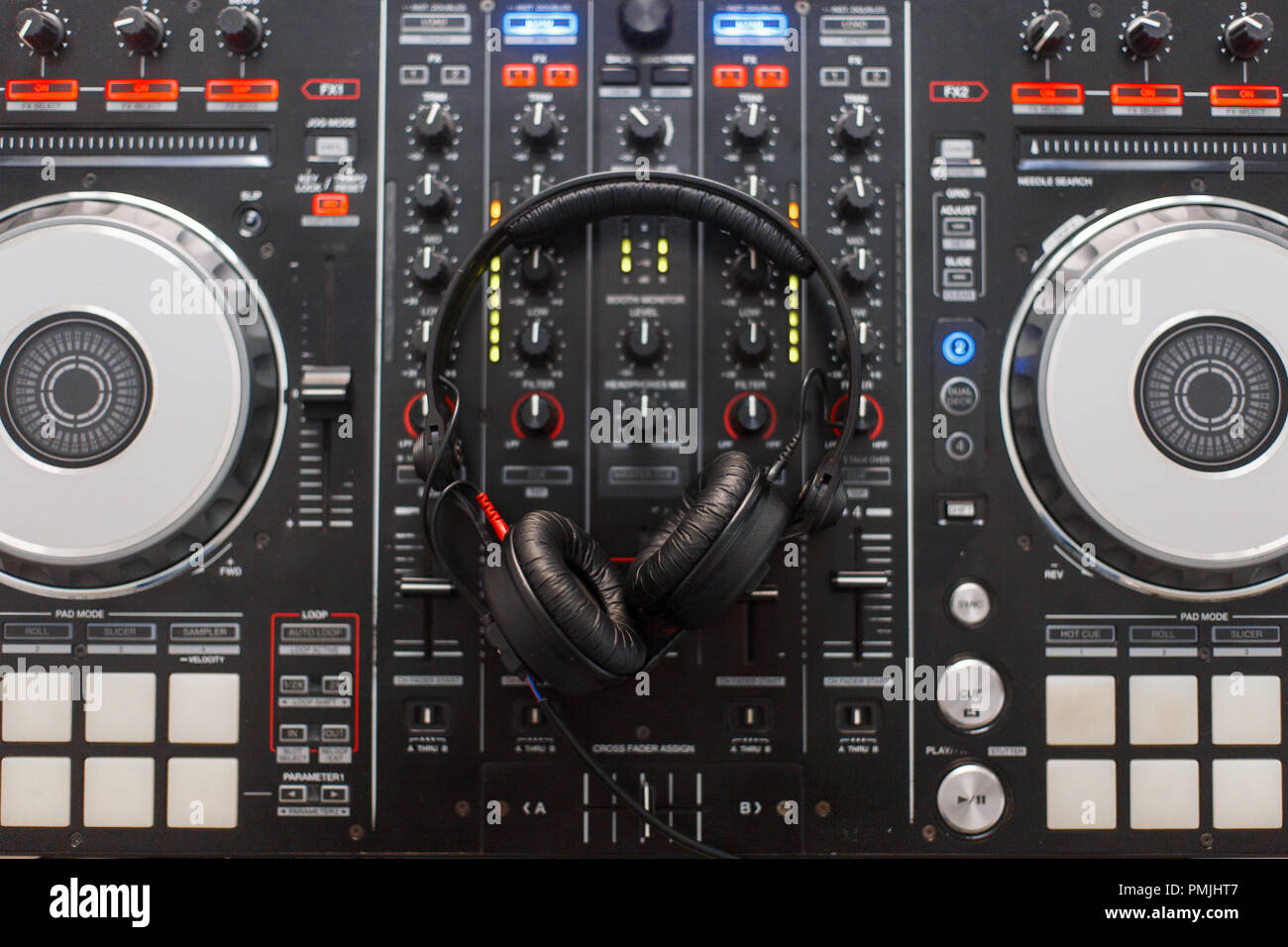 Black modern audio controller and professional headphones. Set of DJ ...