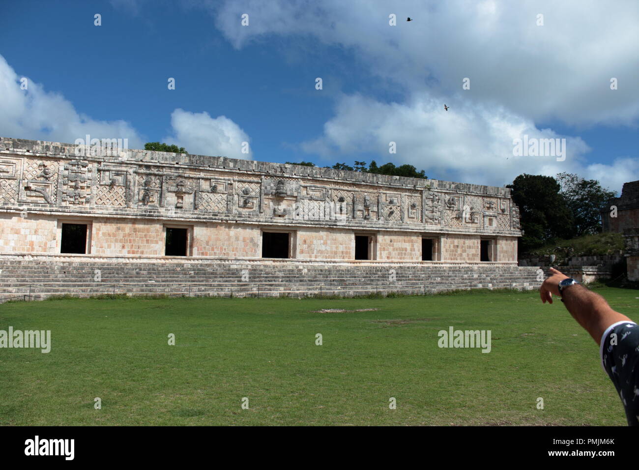 couple of tourists visiting the archaeological site of Uxmal in Mexico ...