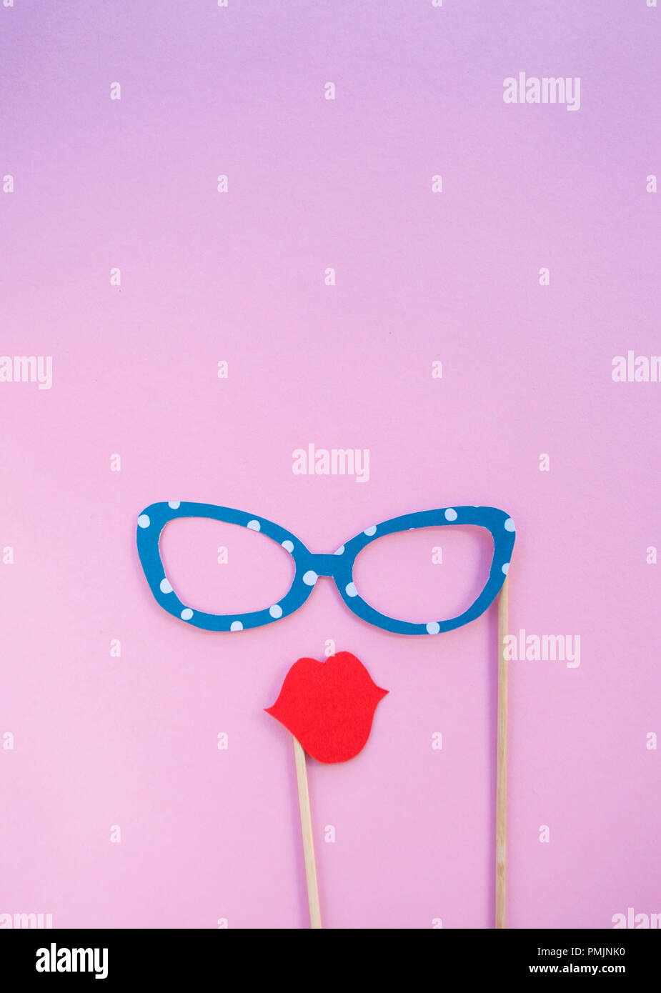 Colorful photo booth props glasses and lips on pink background with ...