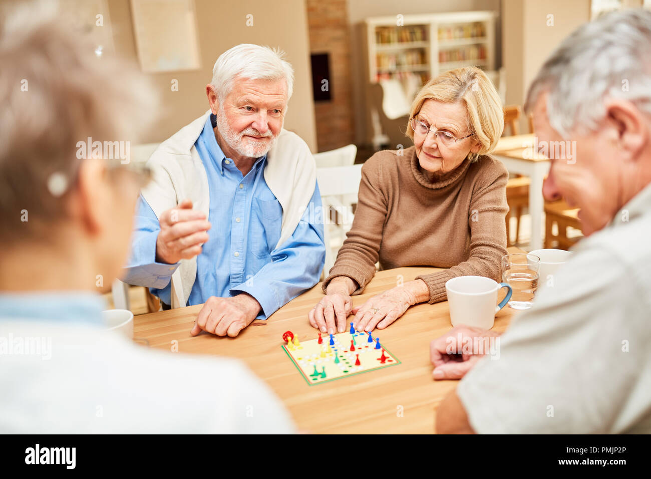 Seniors play board game together hi-res stock photography and images ...