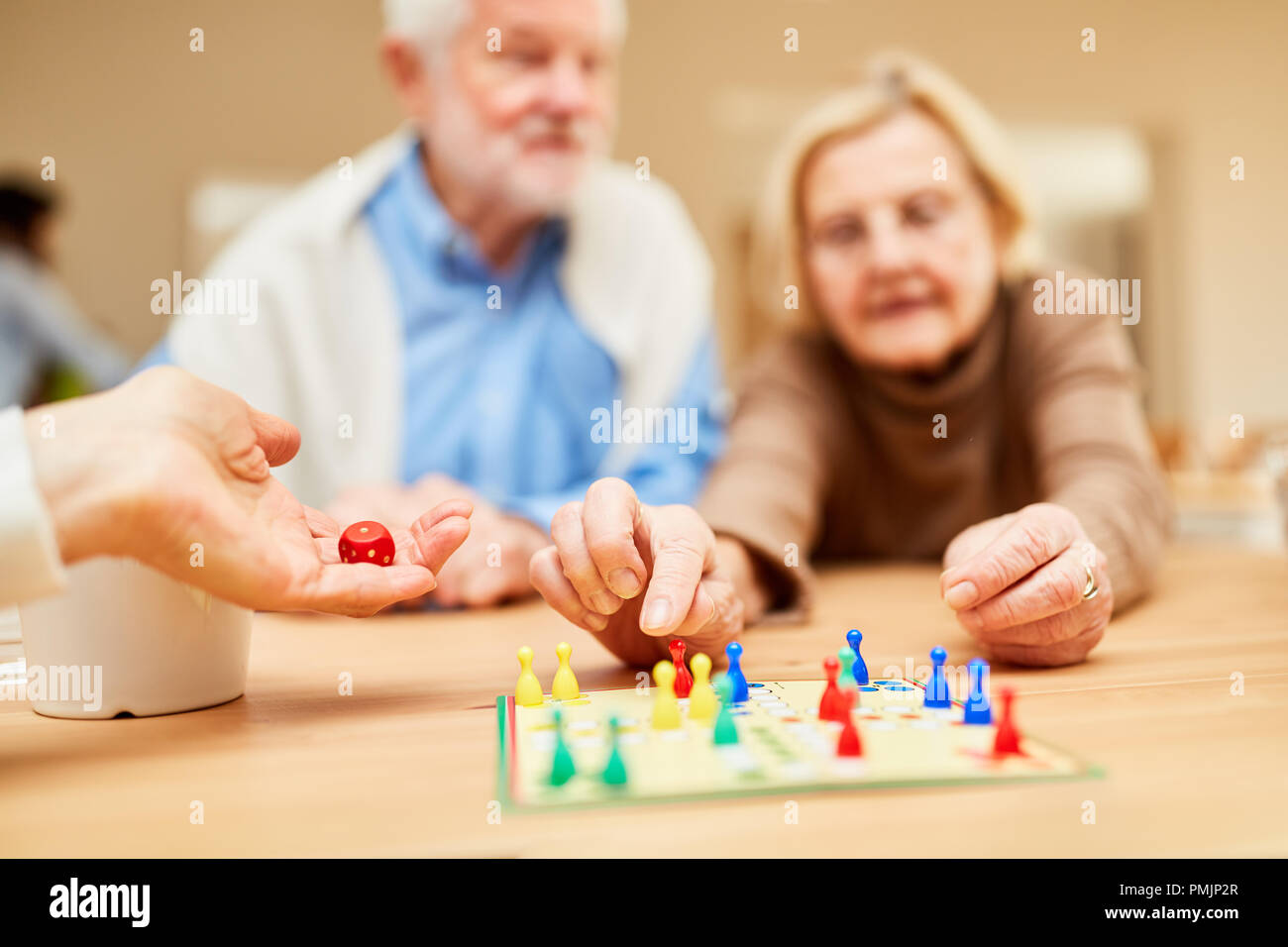 Seniors play a board game as a dice game as employment in the ...