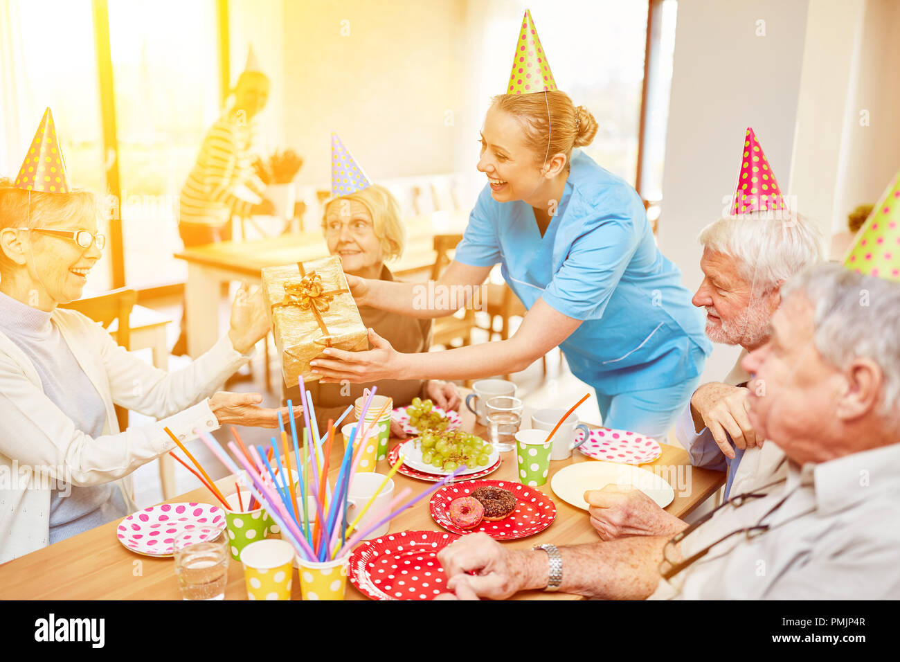 Seniors celebrate birthday together in the retirement home with cake ...