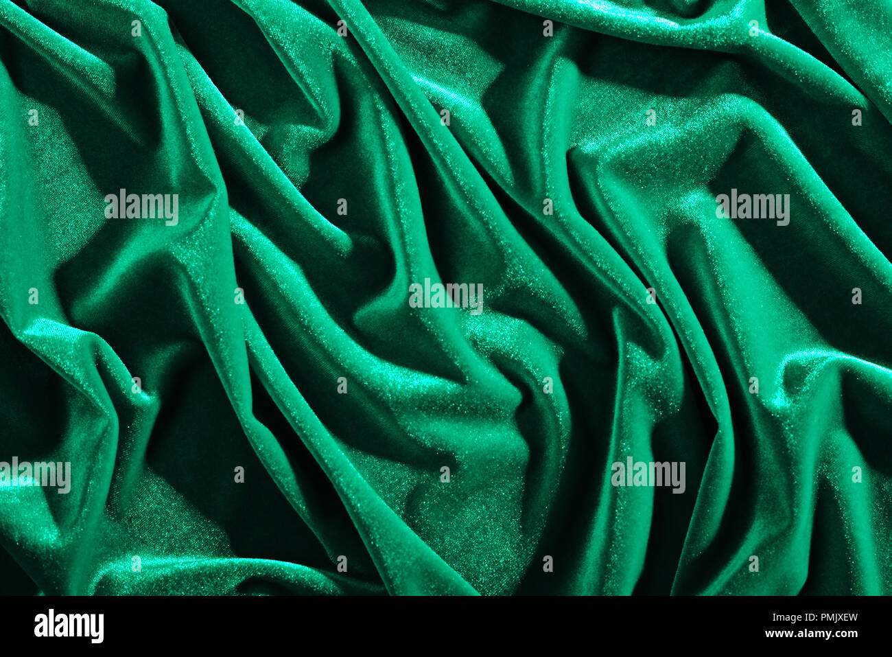 Emerald color velvet textiles for background or texture, wrinkled and ...