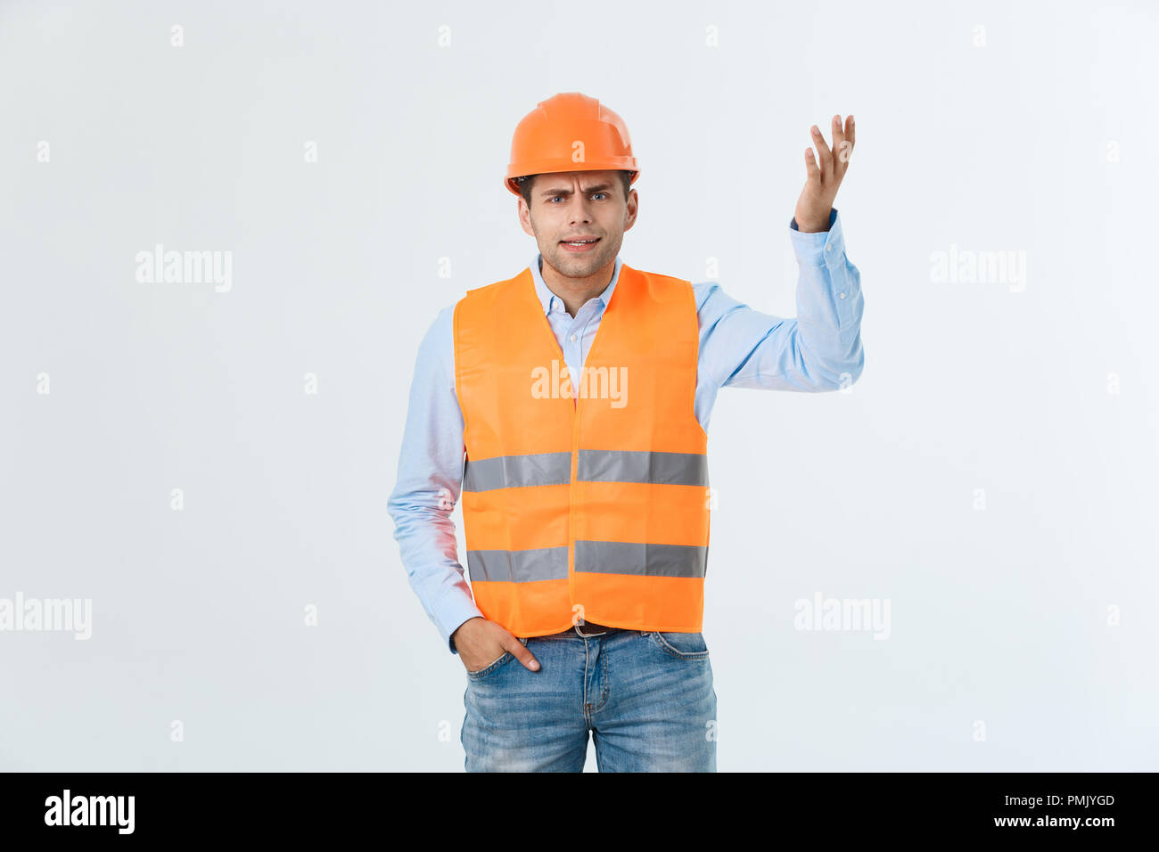 Handsome young engineer man over white background wearing safety helmet ...