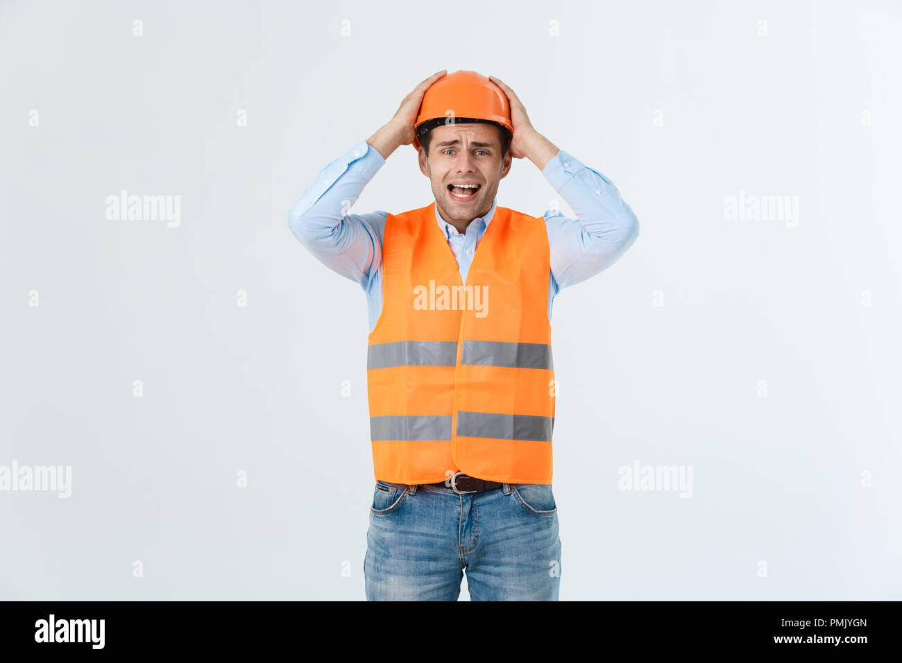 Handsome young engineer man over white background wearing safety helmet ...