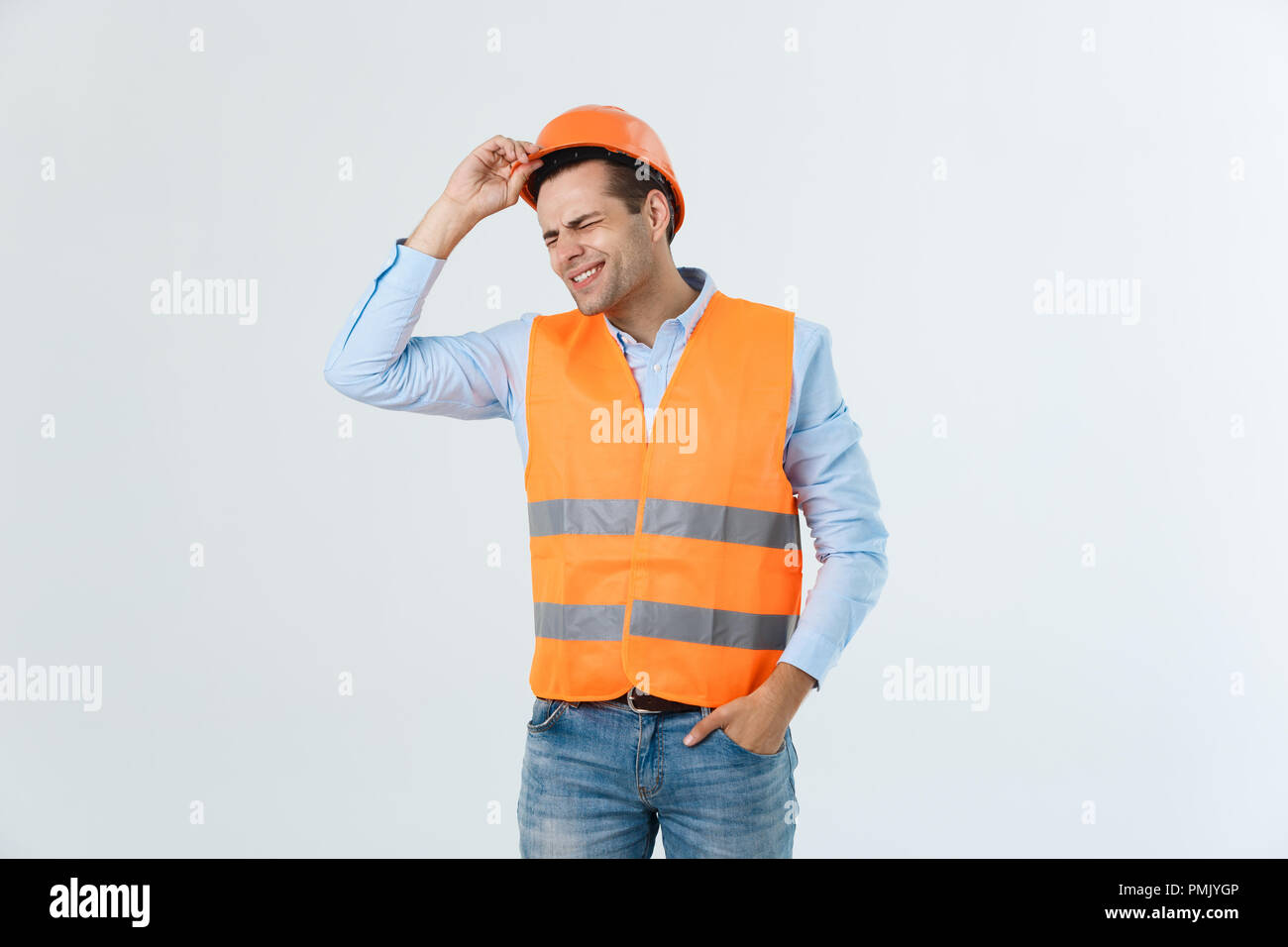 Handsome young engineer man over white background wearing safety helmet ...