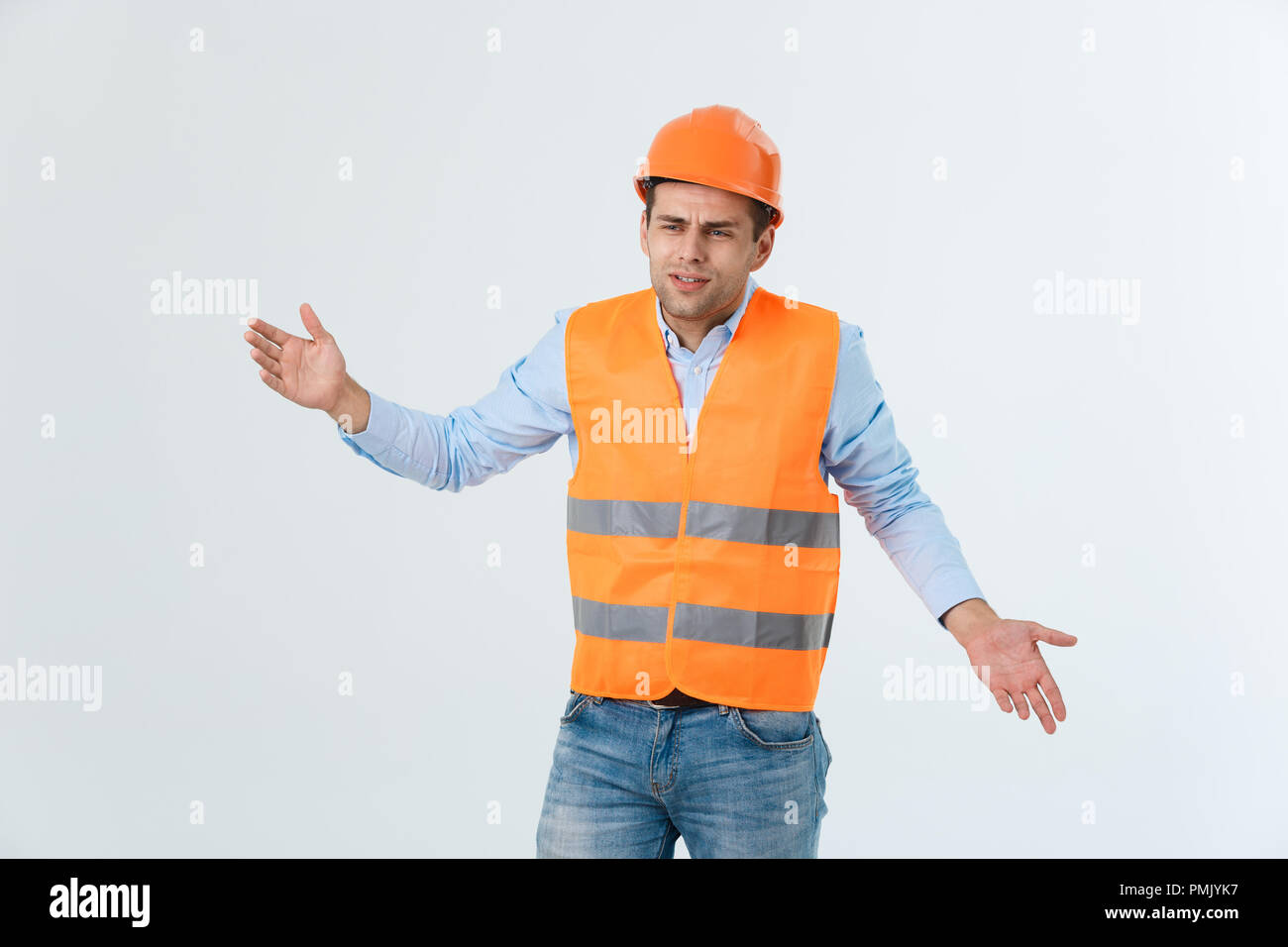 Handsome young engineer man over white background wearing safety helmet ...