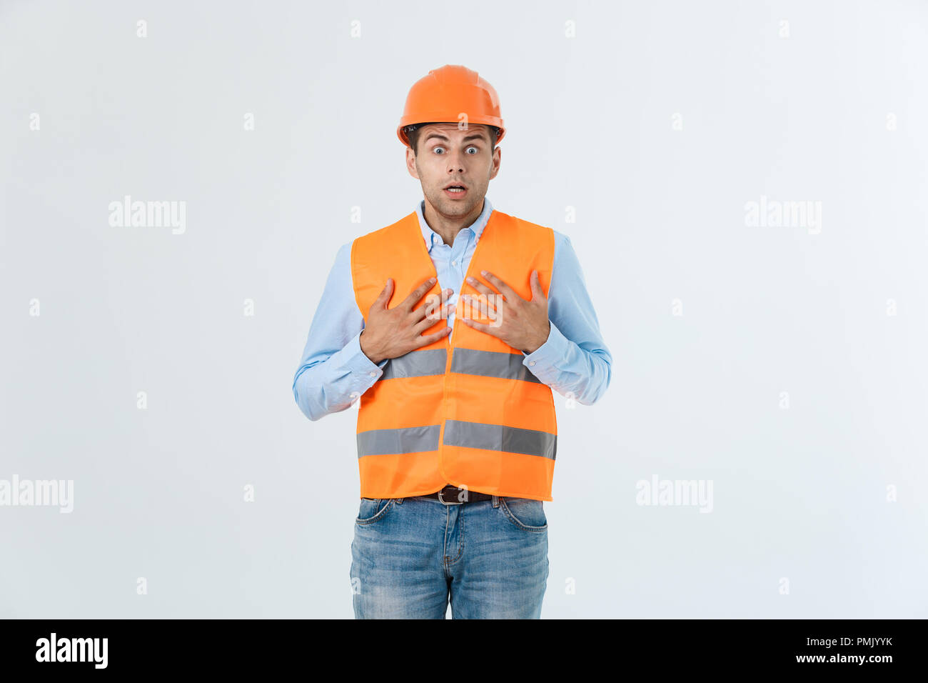 Handsome young engineer man over white background wearing safety helmet ...