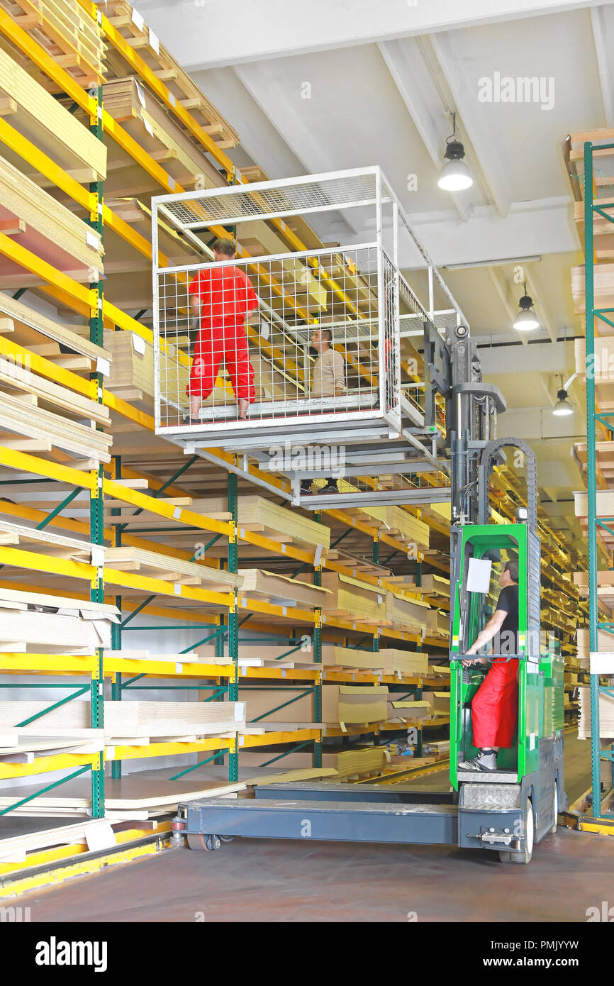 Workers Handling Wood Board in Side Loader Forklift Stock Photo - Alamy