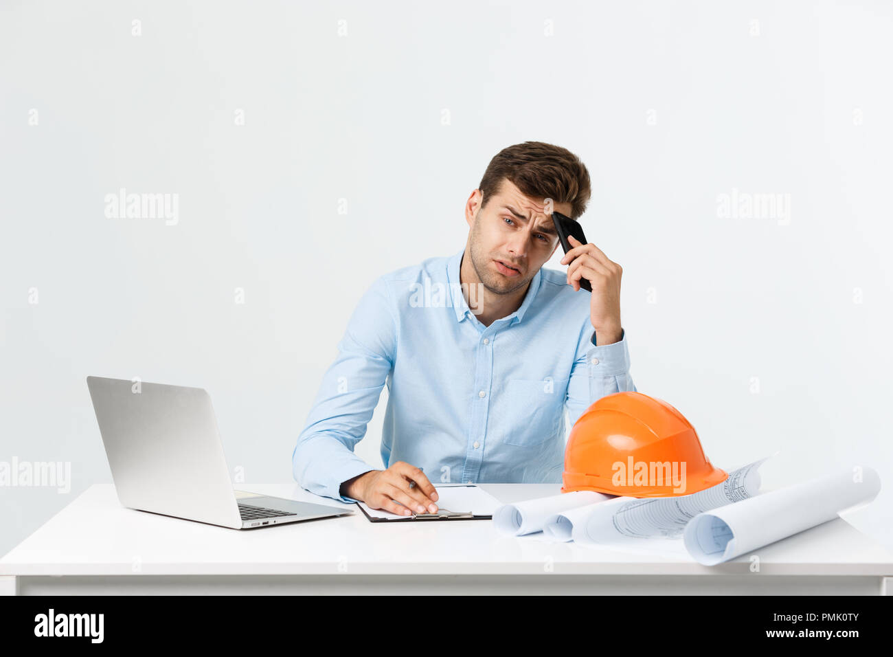 Serious man businessman or engineer sitting in construction site ...