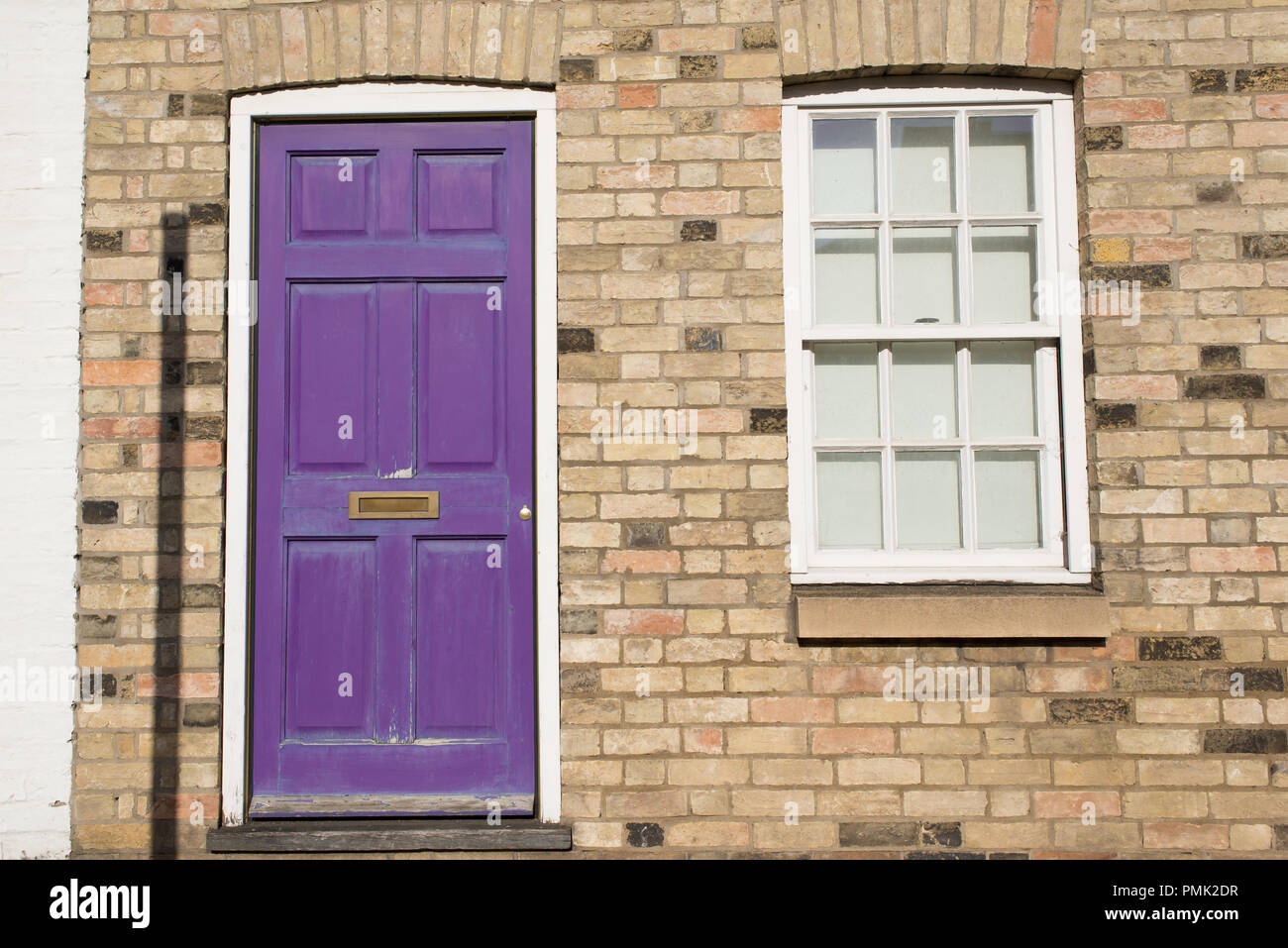 Violet pastel vintage front door on a restored brick wall of a Georgian ...