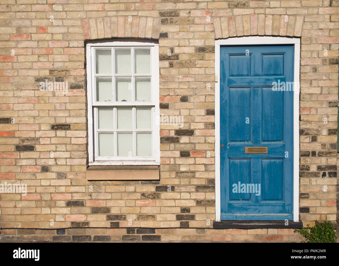 Blue vintage front door on a restored brick wall of a Georgian house ...