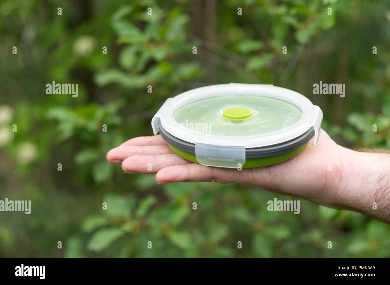 Compact dish. Folding plate. Plate with a lid Stock Photo - Alamy