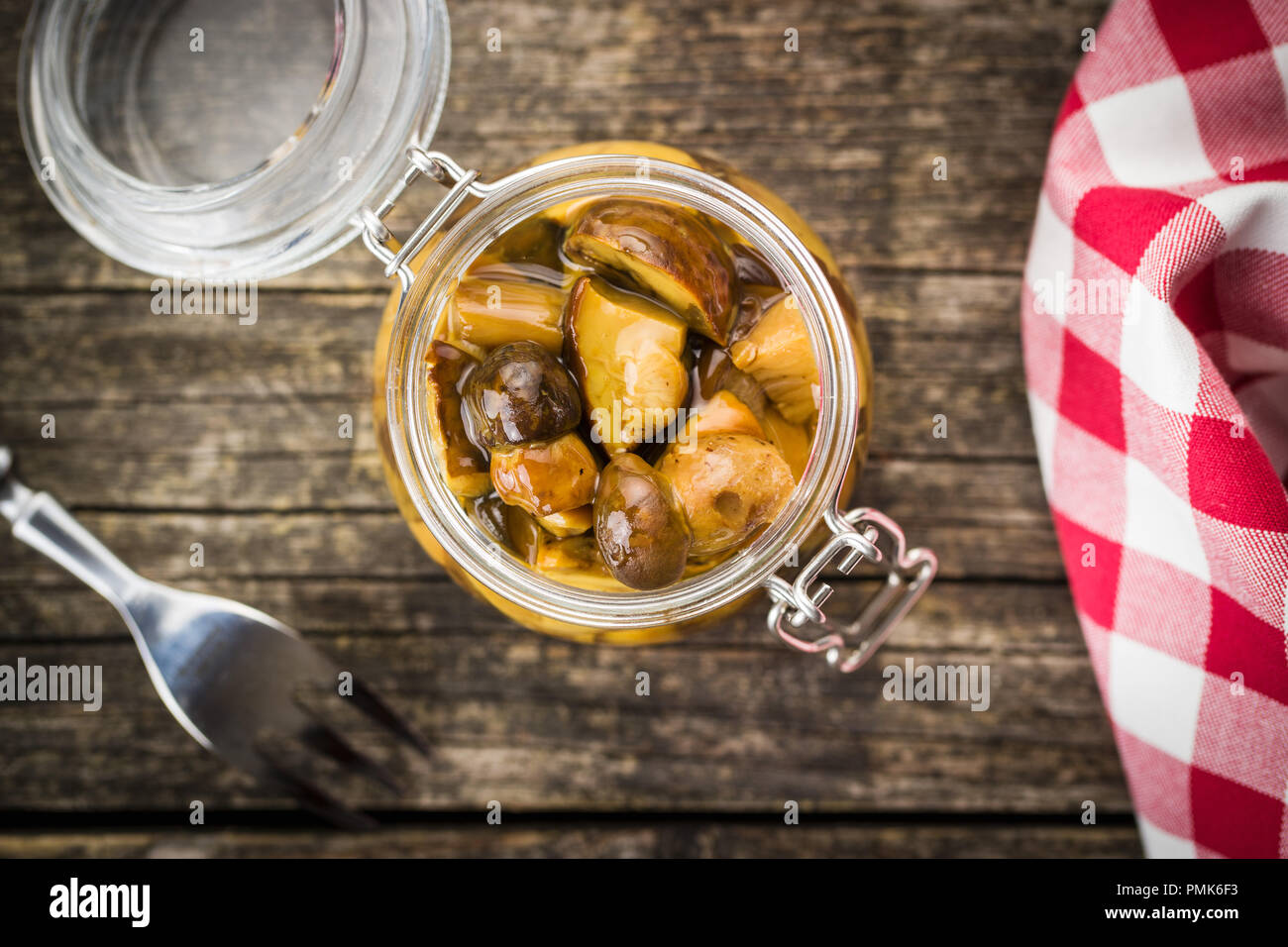 Pickled mushrooms. Marinated boletus in jar Stock Photo - Alamy
