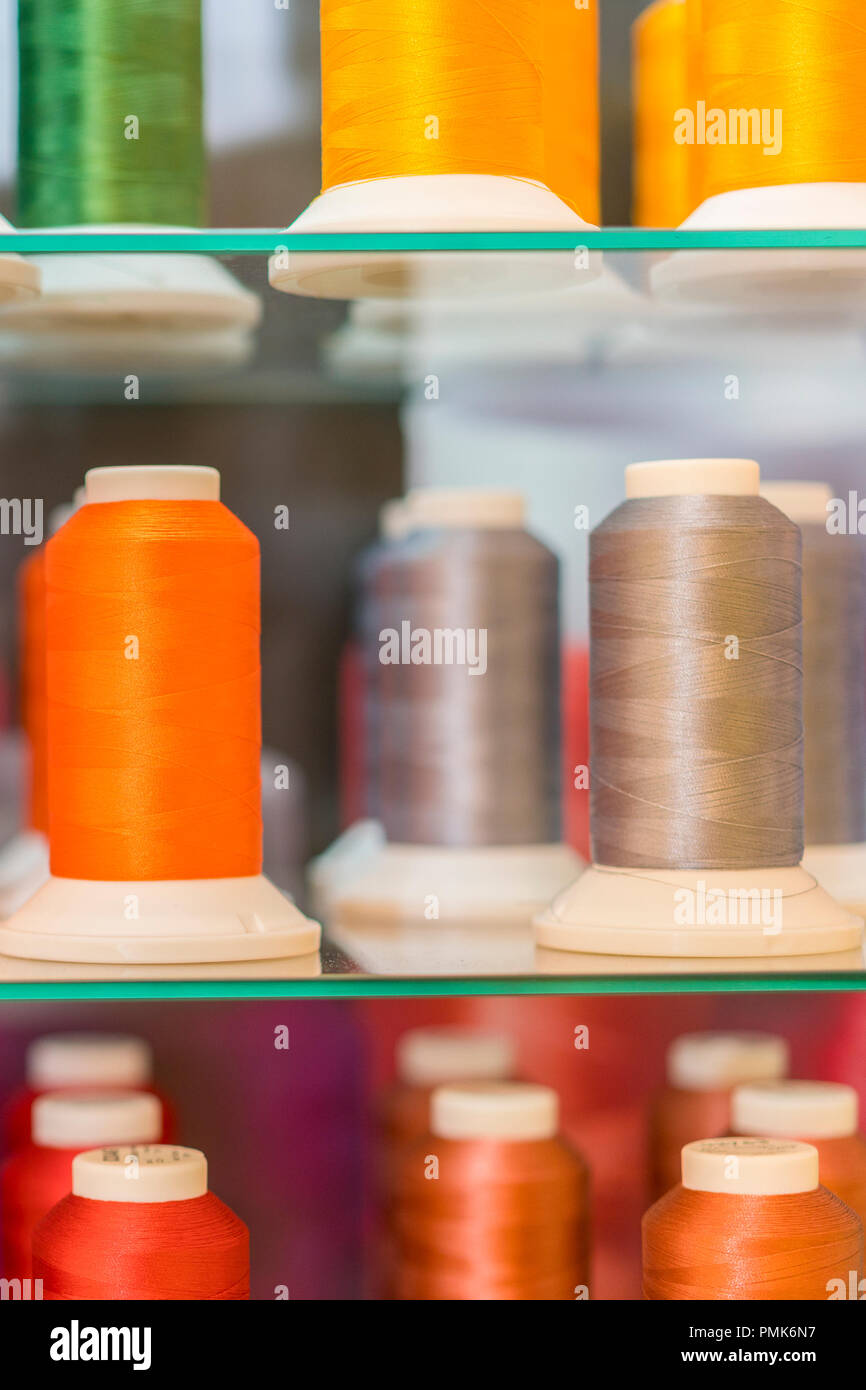 Background with a lot of colorful coils with threads. Bobbins are ...