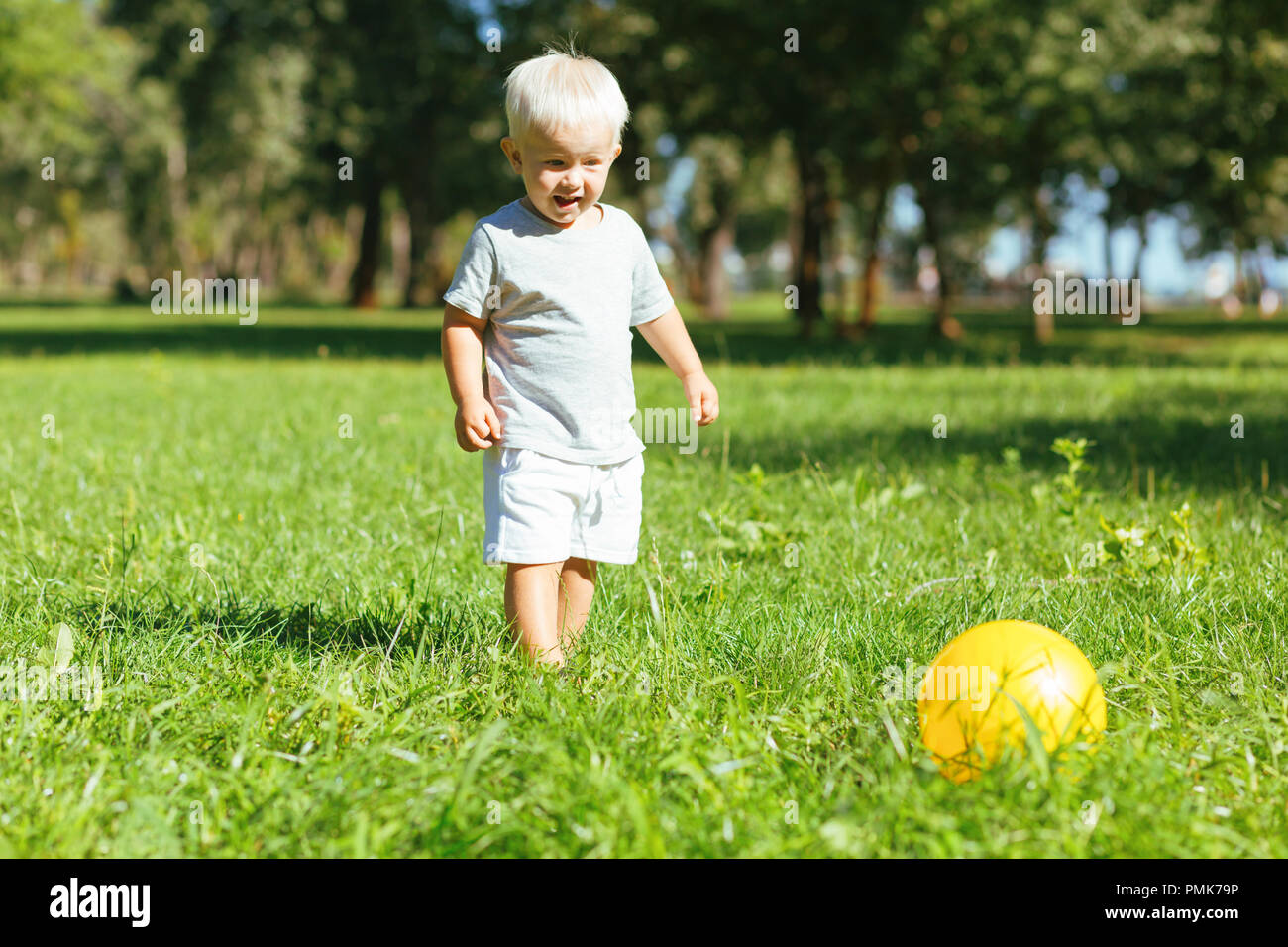 Child kicking a ball hi-res stock photography and images - Alamy